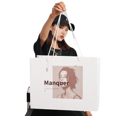 China Custom Printed White Paper Premium Luxury Shopping Bags With Ribbon Handle Design for sale