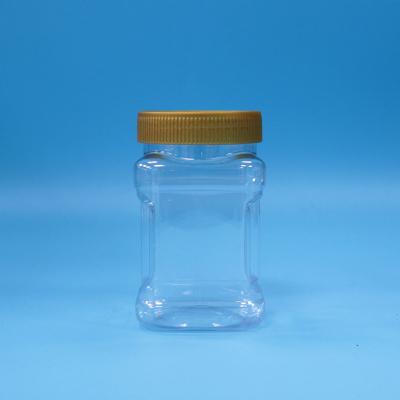 China 450ml 70mm Food Grade PET Candy Jar Airtight Clear Plastic with Brown Flat Lid for sale