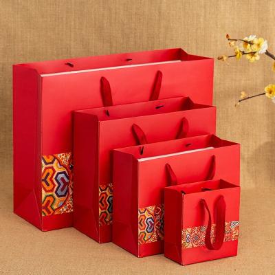 China Custom Design Logo Red Exquisite Special Paper Packaging Bag Shopping Gift Bags With Handle for sale
