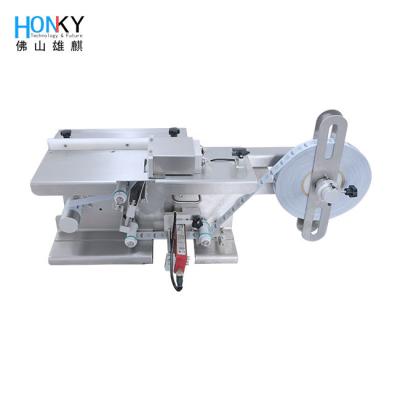China Manual Small Box Corner Labeling Machine with Transparent Label Sensor and Adjustable Labeling Height at 55-60 Pcs per minute for sale