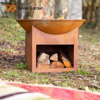 China Round Outdoor Garden Wood Burning Corten Steel Fire Pit 3mm With Wood Storage for sale