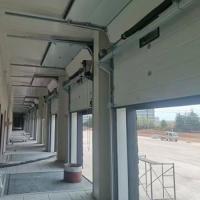 China 30000-Cycle Torsion Spring Noise-Reducing Industrial Sectional Overhead Door For Inland Container Depots for sale