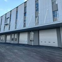 China Heavy Duty Sectional Overhead Door 24dB Sound Insulation Commercial Sectional Garage Doors for sale