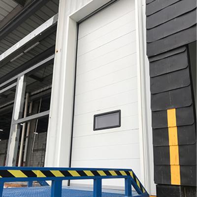 China Heavy Duty Sectional Overhead Door 24dB Sound Insulation Commercial Sectional Garage Doors for sale