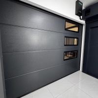 China Insulated Sectional Garage Door with Rubber Sealed Panel Joints and 40 mm Polyurethane Insulated Panels Featuring 1.5 mm Embedded Steel Reinforcement for sale