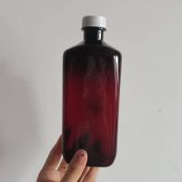China 16 oz Oval Amber PET Plastic Medicine Bottles 500ml with Red CRC Caps for Liquid Medicines for sale