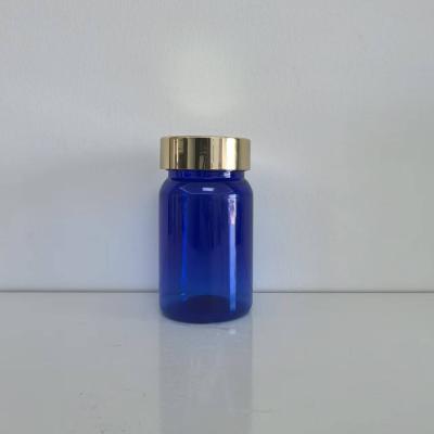 China 70ml Cobalt Blue PET Capsule Bottle with Gold Plated Aluminum Lid for Pill Supplement Packaging for sale