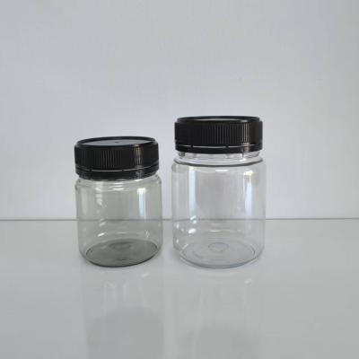 China 200ml 250ml Round PET Plastic Bottle with Black Anti Theft Screw Cap for Food Packaging for sale