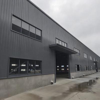 China Q235 Q345 Q355 Steel Grade Galvanized or Painted Surface Steel Structure Workshop with 200 Km/h Wind Load Portal Frame Workshop for sale
