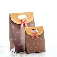 China Boutique Craft Coloured Paper Gift Bags With Self Adhesive Ribbon for sale