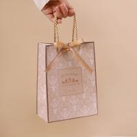 China Cattle Paperboard Custom Kraft Paper Handbag Cosmetics Packaging Gift Bags With Cowhide Rope for sale