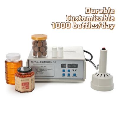 China Mini Manual Electromagnetic Induction Sealing Machine with 100-500W Adjustable Power and Copper Coil for 20-130mm Applicable Caliber for sale