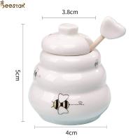 China Wholesale White Empty Honey Jar Ceramic Honey Pot with wooden dipper for honey storage for sale