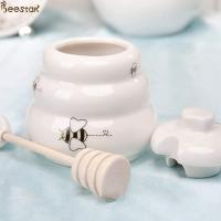 China Wholesale White Empty Honey Jar Ceramic Honey Pot with wooden dipper for honey storage for sale