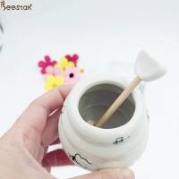China Wholesale White Empty Honey Jar Ceramic Honey Pot with wooden dipper for honey storage for sale