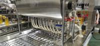 China Spoon Type Honey Packaging Machine 10-12 Head Automatic Honey Filling Machine for sale
