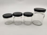 China 50ml 75ml Bird Nest Bottle Round Glass Honey Pot Glass Container Bottles With Black Lid for sale