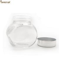 China 50ml Honey Jar And Spoon Flat Bottle With Metal Lid for sale