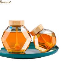 China 380ML Glass Honey Hexagon Jar With Wooden Cover And Wooden Splash Bar for sale