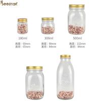 China Carved Flower Honey Glass Jar And Spoon Transparent Honey Container for sale