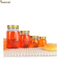 China Carved Flower Honey Glass Jar And Spoon Transparent Honey Container for sale