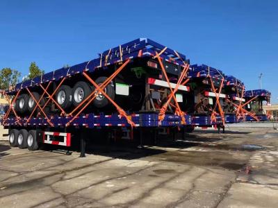 China Flat Bed Container Transport 4 Axle Flatbed Semi Trailer 16 Tires Not Self Dumping for sale