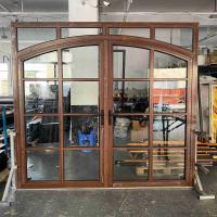 China Arched Aluminum Hinged Doors with 2.0mm Profile Thickness and 5mm+12A+5mm Double Tempered Glass - French Design Wood Color for sale