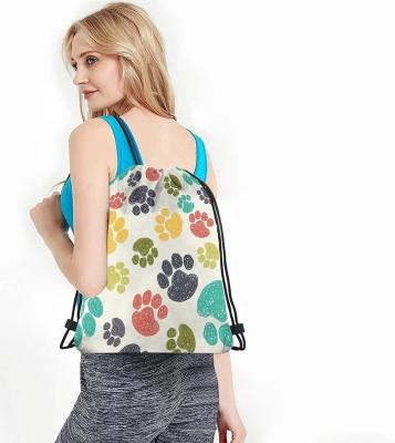 China Digital Printed Drawstring Backpack Bag Hand Drawn Doodle Prints Puppy Footprint Drawing for sale