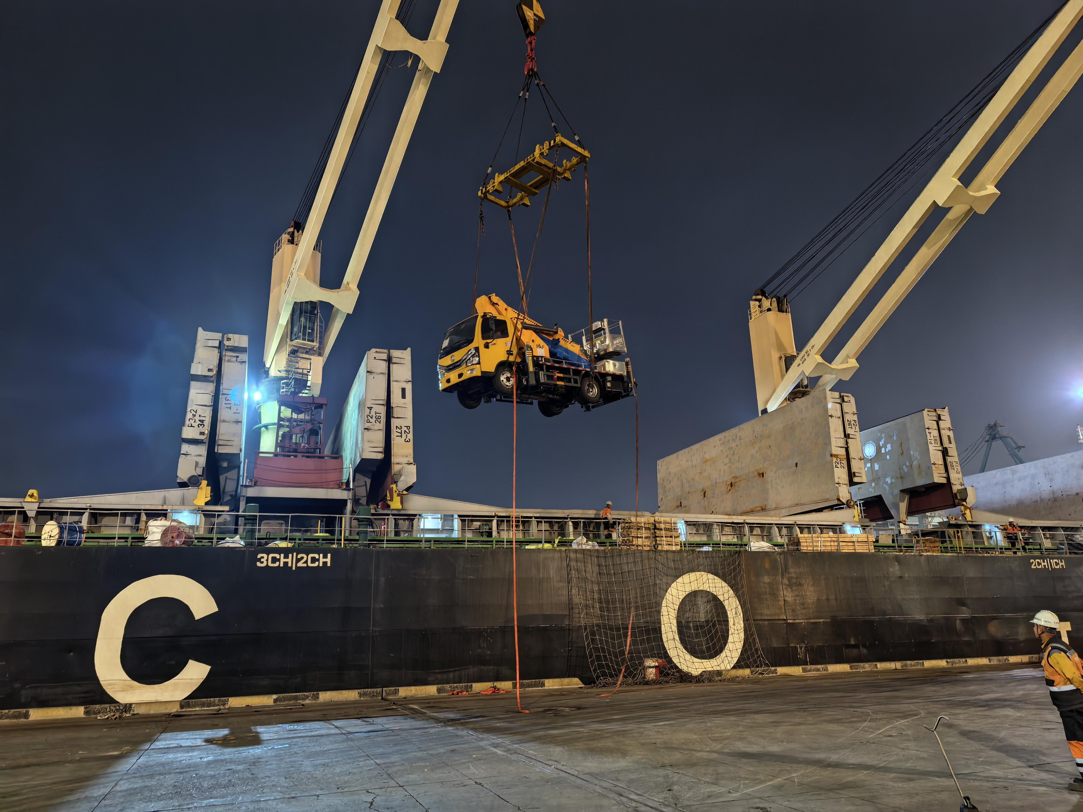 Trucks being loaded onto a ship