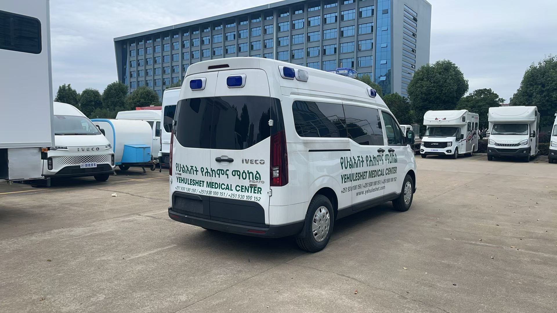 Rear view of the IVECO EV medical ambulance showing dual rear doors and LED emergency warning lights