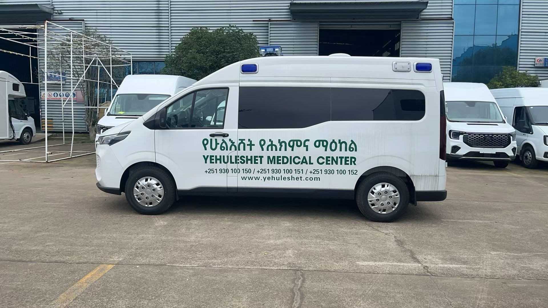 Side profile of the custom IVECO electric medical van featuring bilingual Amharic and English hospital decals