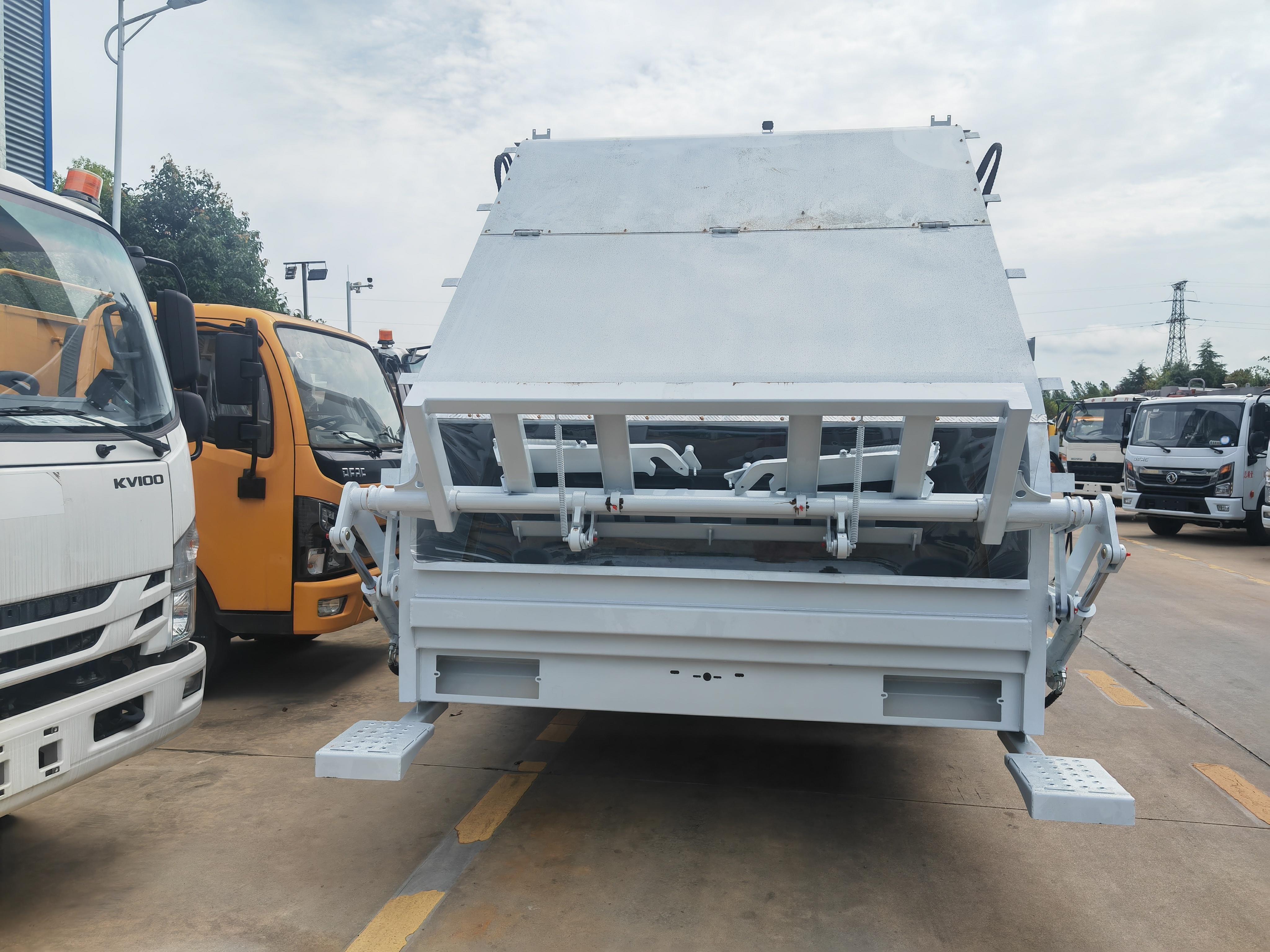 Rear view of Dongfeng waste compactor truck showing universal waste bin-flipping mechanism and lifting frame