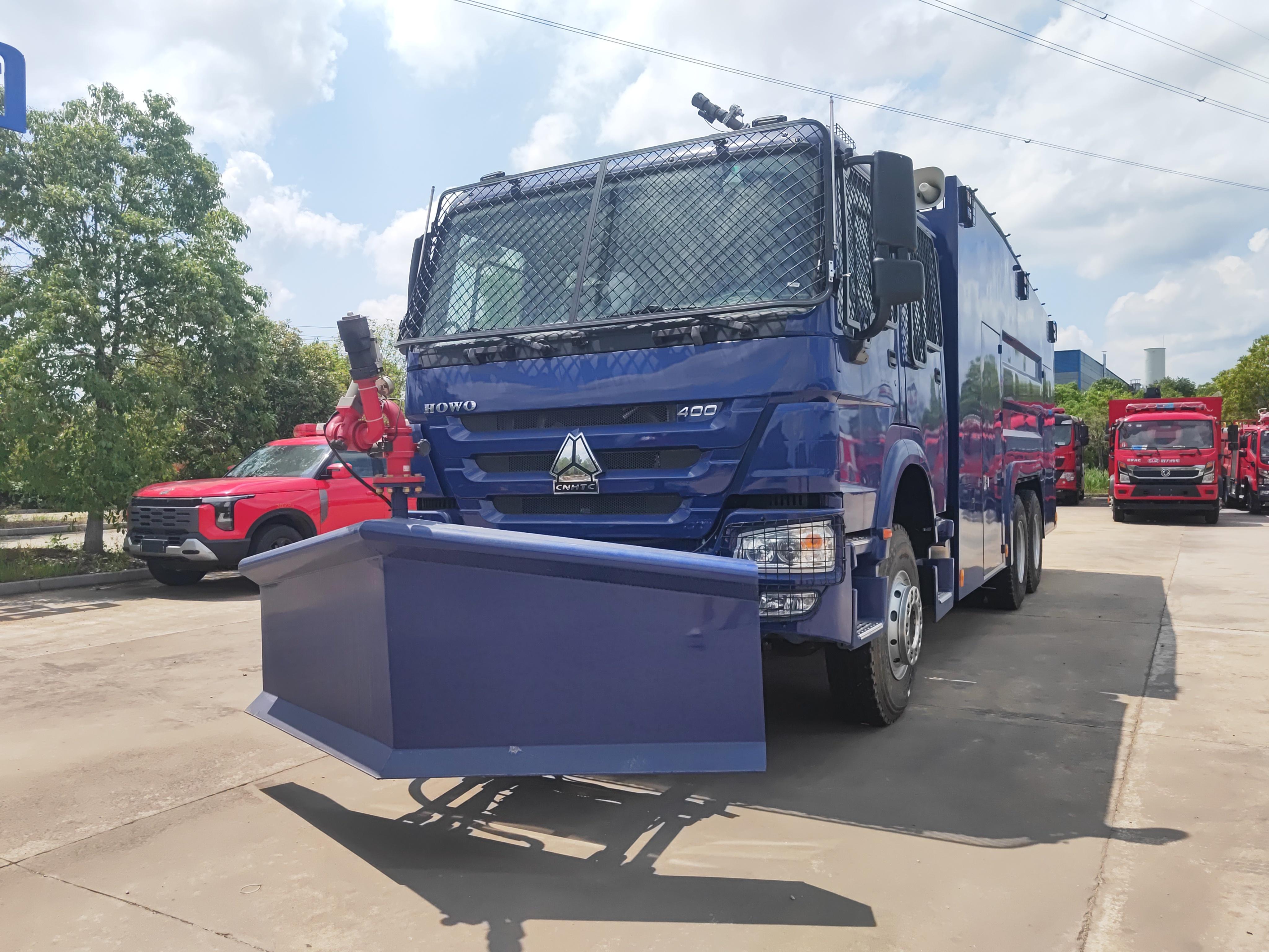 Side view of navy blue SINOTRUK HOWO 6x4 anti riot vehicle with roof mounted water cannon and perimeter warning lights