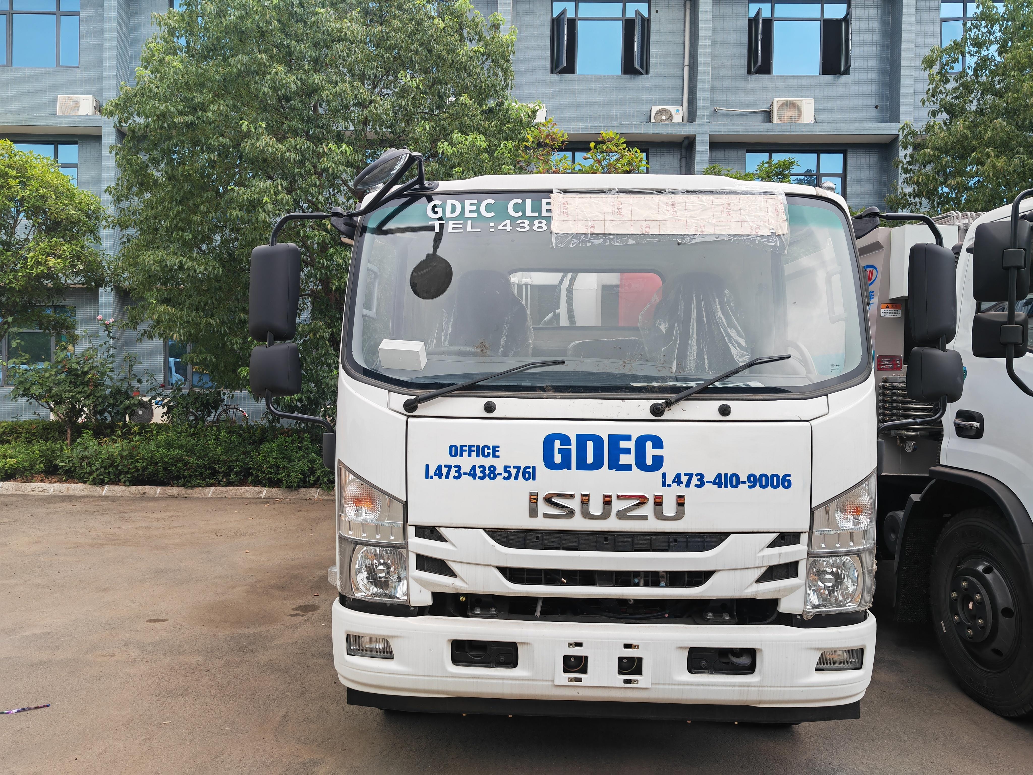 Front view of ISUZU compactor garbage truck with GDEC logo exported to Grenada by Clw AUTOMOBILE Group