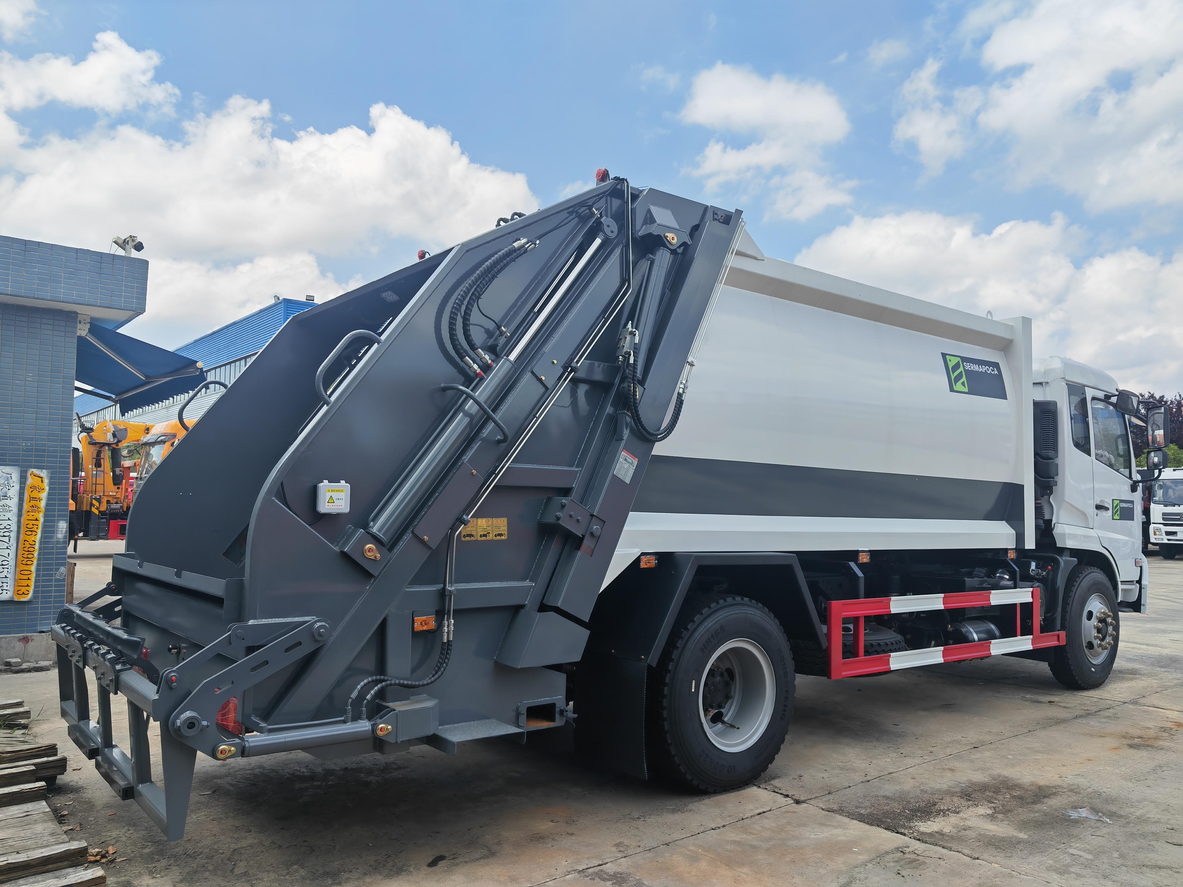 Rear side view of CLW waste compactor vehicle showing heavy duty tailgate and loading hopper