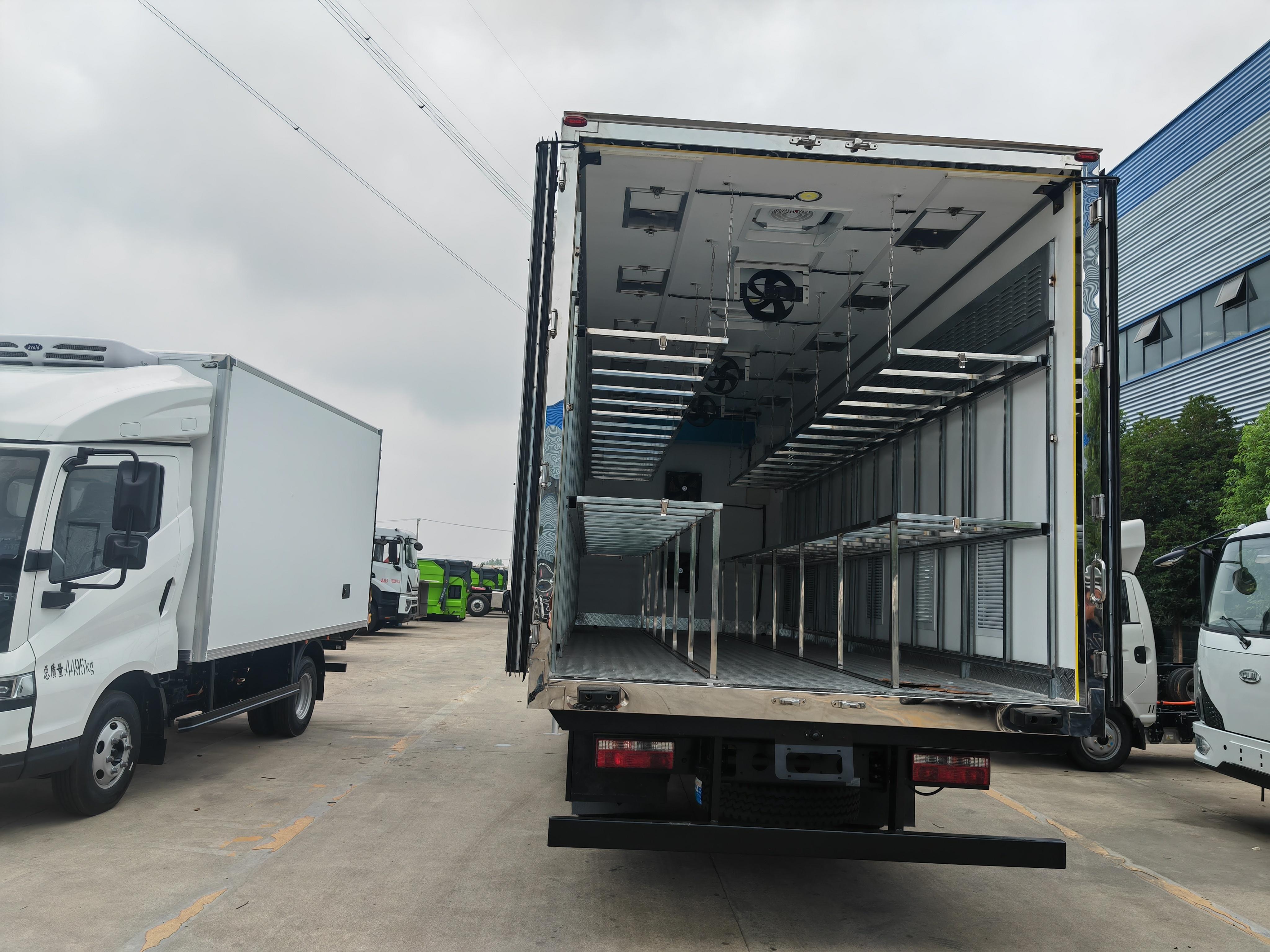 Internal view of the CLW chick transport truck cargo body with multi-tier racking and ventilation fans
