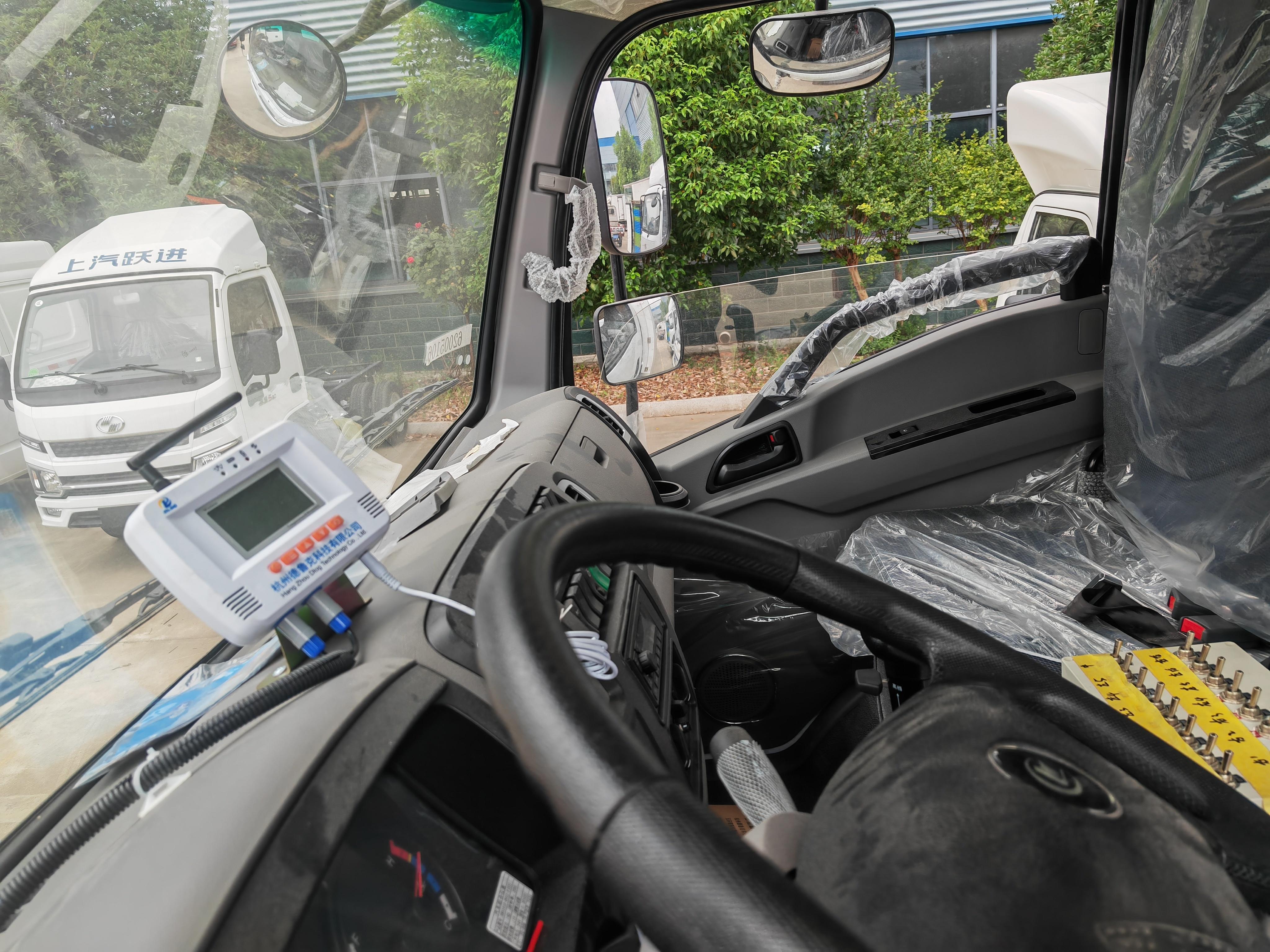 Interior cab view of the transport truck showing the climate controller unit on the dashboard