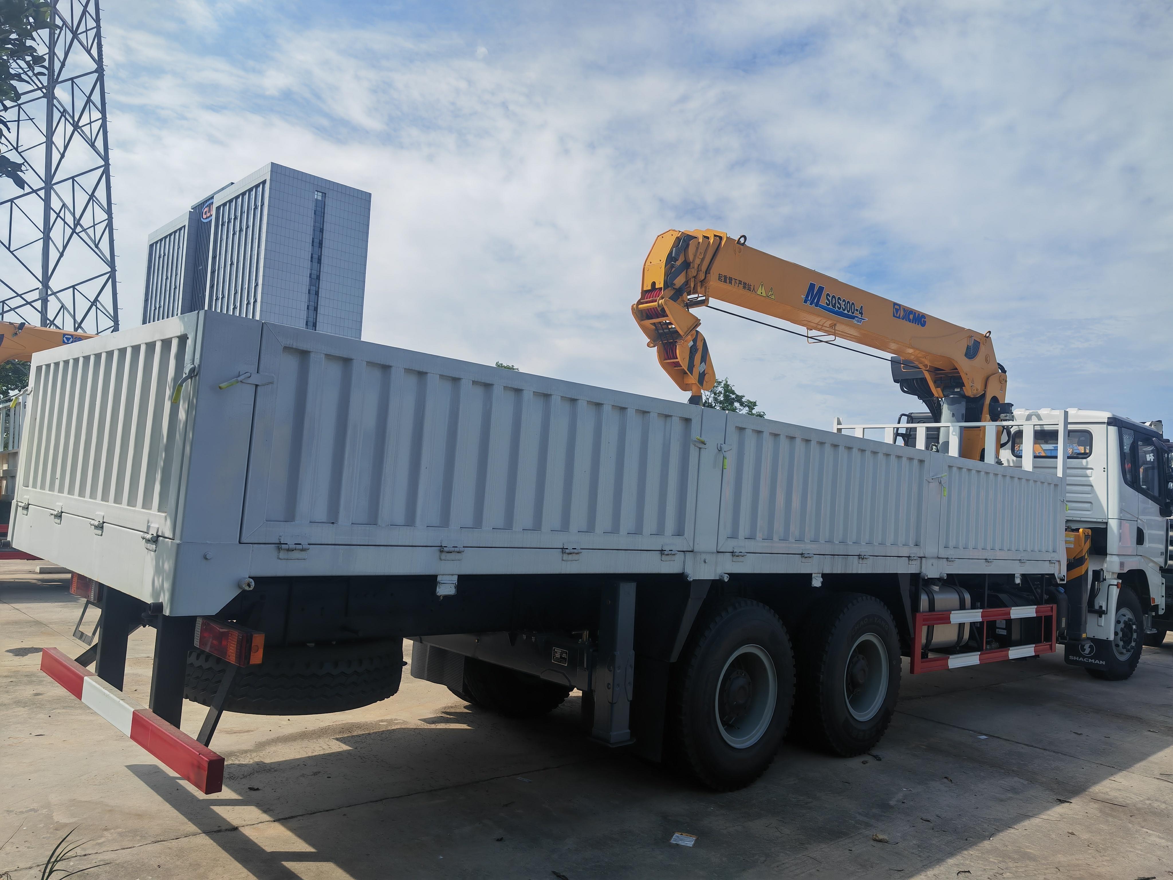 Shacman X3000 cargo box and XCMG straight boom crane mounted on rear chassis