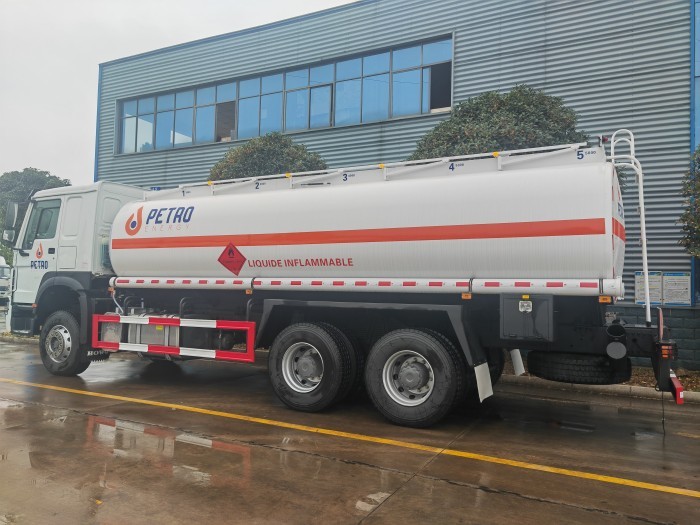 Right side view of HOWO 20cbm fuel tanker truck showing multi-compartment manholes and rear ladder