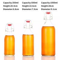 China Round 600ml Glass Bottle With Stopper Caps Carafe Swing Top Beer Bottle Kombucha Bottle Beverage for sale