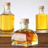 China 280ml Cosmestic Whisky Bottle with Stripe and Embossing in Transparent Triangle Shape for sale