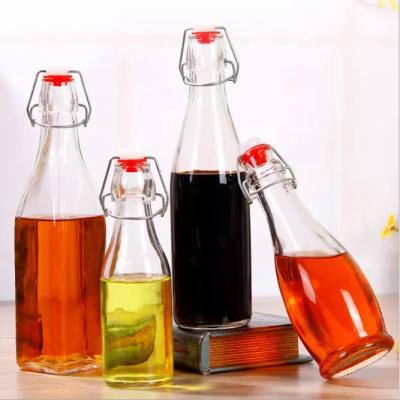 China Glass Bottle Sealing Type Cork 150ml 250ml 500ml 1000ml Round Shape Swing Top Wine Whiskey Bottles for sale