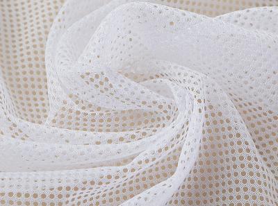 China Customized knitted big mesh polyester tulle hexagonal textile fabric cloth back lining for sale