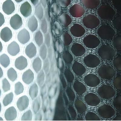 China Polyester Hexagonal Mesh Fabric 130gsm 1.55m Width for Bags Garments Laundry for sale