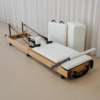 China Eco Friendly Beech Wood Pilates Reformer Foldable Core Bed for Studio Custom Color 3 Year Warranty for sale