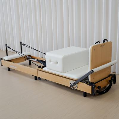 China Space Saving Foldable Wooden Pilates Reformer Portable Home Pilates Bed Small Apartment Yoga Training Machine for sale
