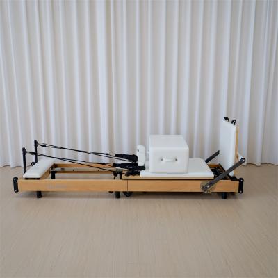 China Foldable Wooden Pilates Reformer Easy Move Home Pilates Machine With Wheels For Small Space Training for sale