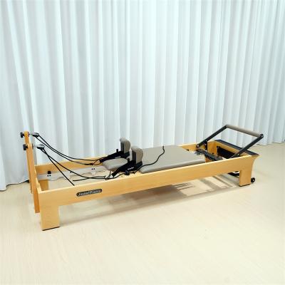 China Professional Beech Wood Pilates Reformer with Adjustable Spring System and Built-in Footbar for sale