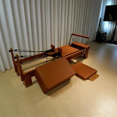 China Wenge Wood Pilates Reformer Bed Full Set with Adjustable Footbar and Pilates Accessories
Premium Wooden Pilates Reformer Equipment with Tower System for commercial use Gym and Studio for sale