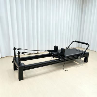 China User friendly Pilates Reformer machine featuring adjustable springs padded platform and sturdy frame for performance for sale